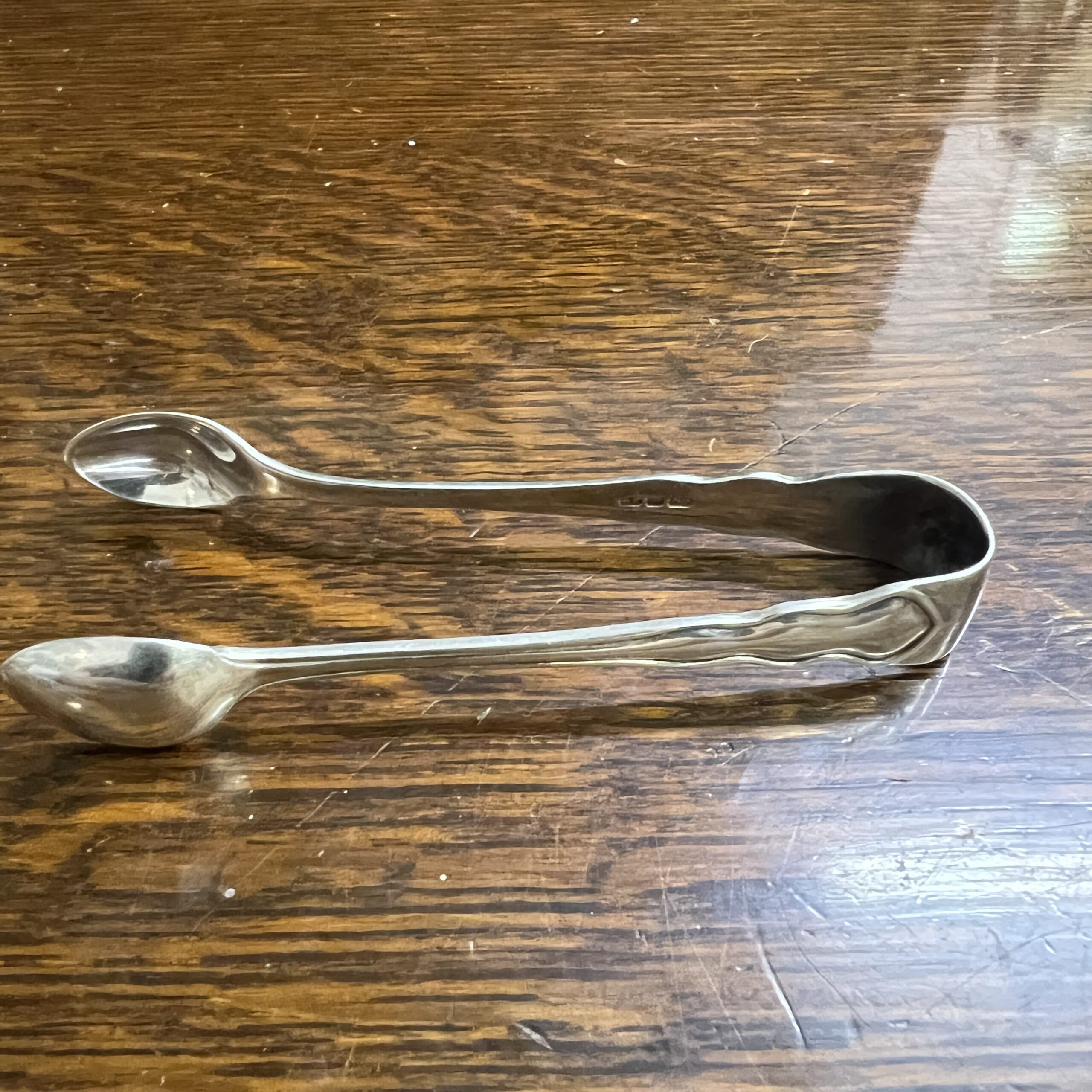 A pair of silver plated sugar tongs - South Perth Antiques & Collectables