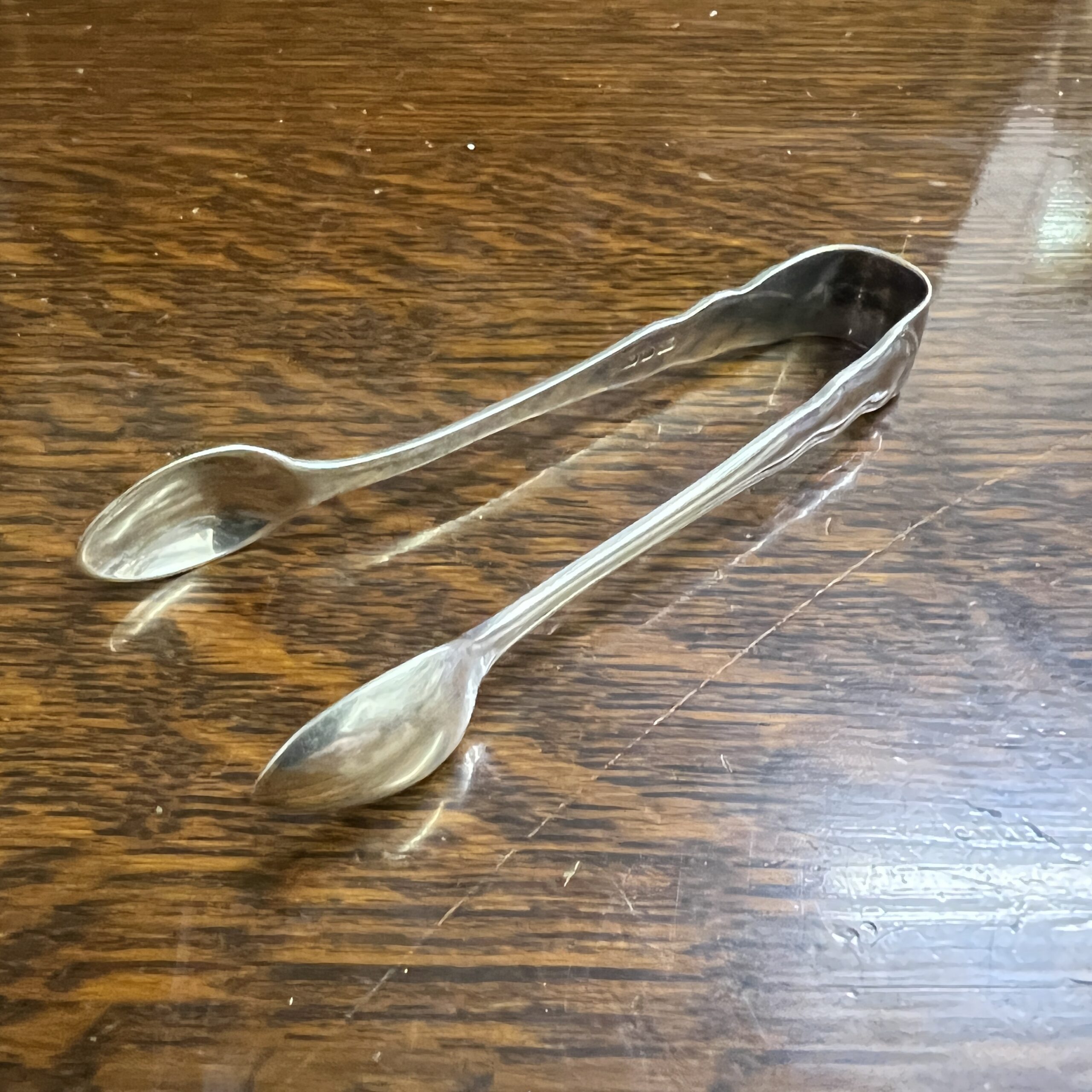 A pair of silver plated sugar tongs - South Perth Antiques & Collectables