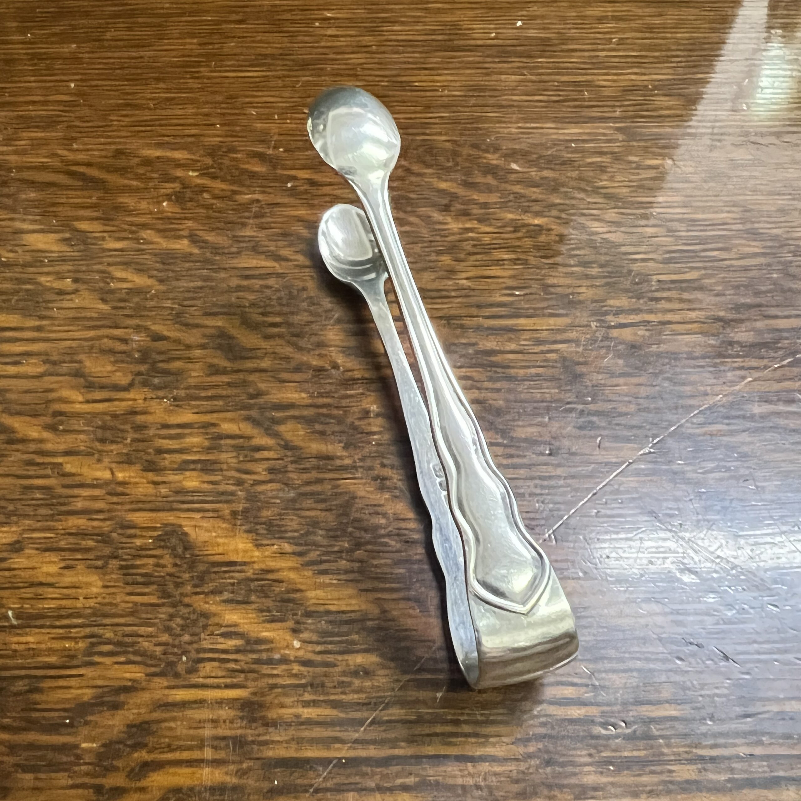 A pair of silver plated sugar tongs - South Perth Antiques & Collectables